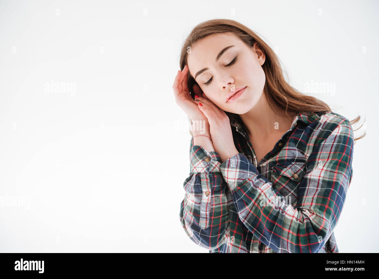 Tender beautiful young woman with eyes closed standing and touching her ...