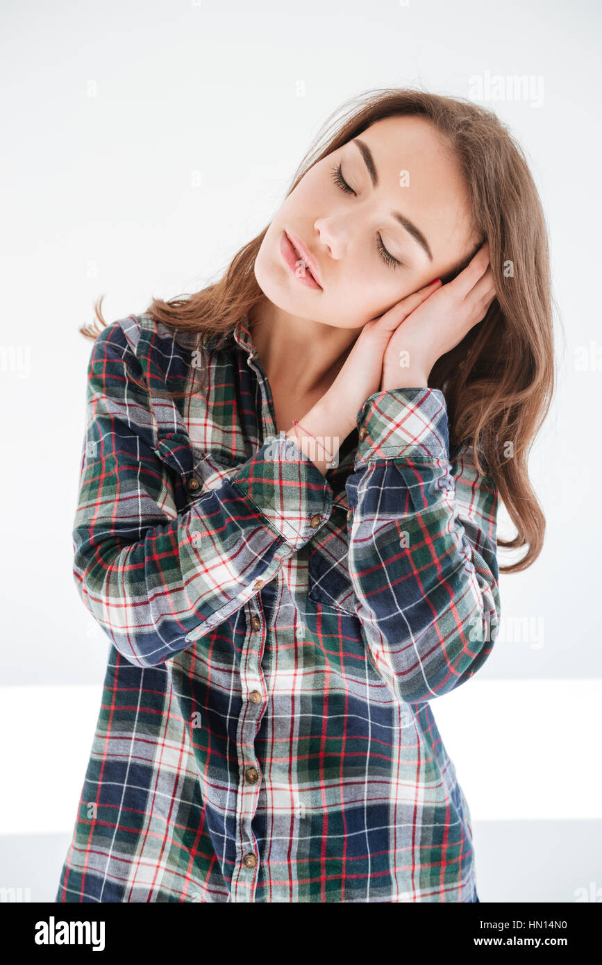 Image of pretty woman standing over white background while sleeping on ...