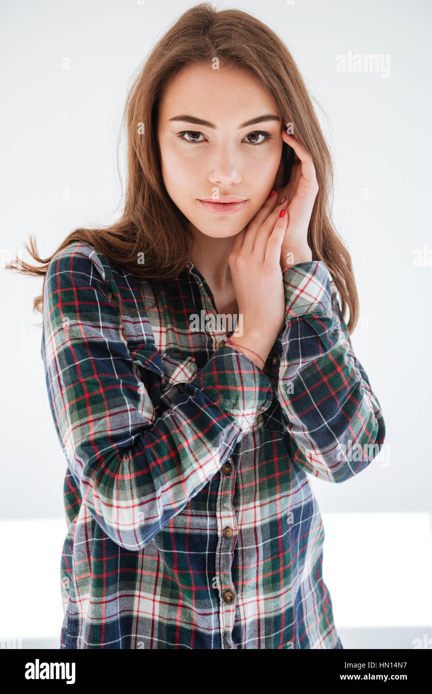 Picture of beautiful woman standing over white background while look at ...