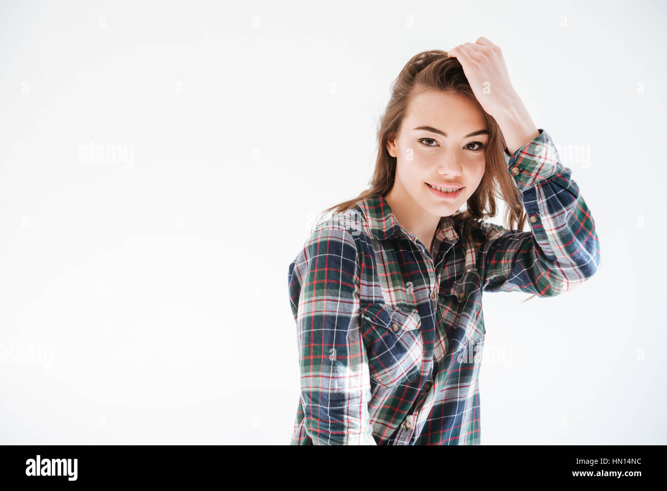 Photo of pretty woman standing over white background while look at ...