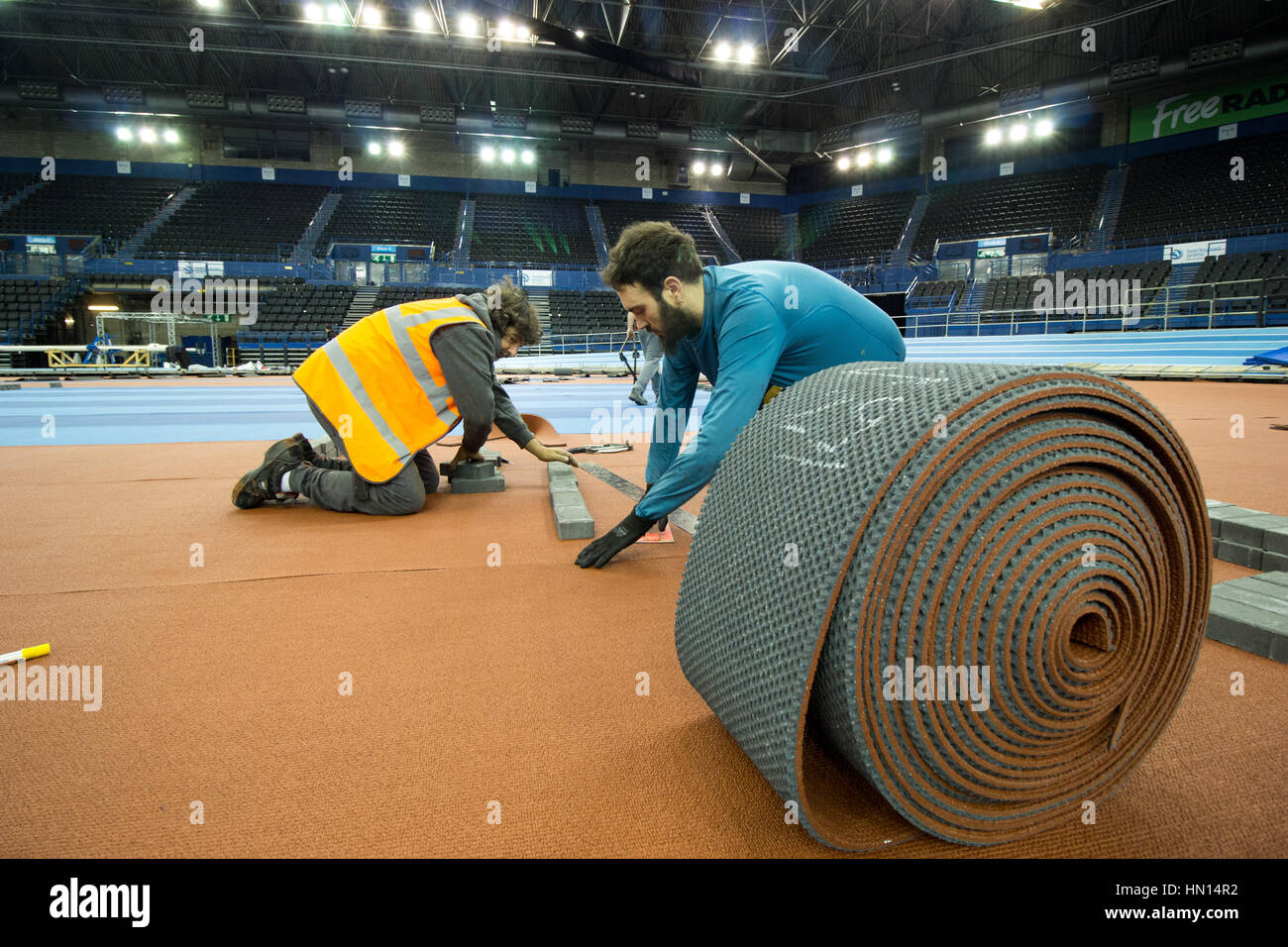 Workers laying the new infield track at the National Indoor Arena in ...