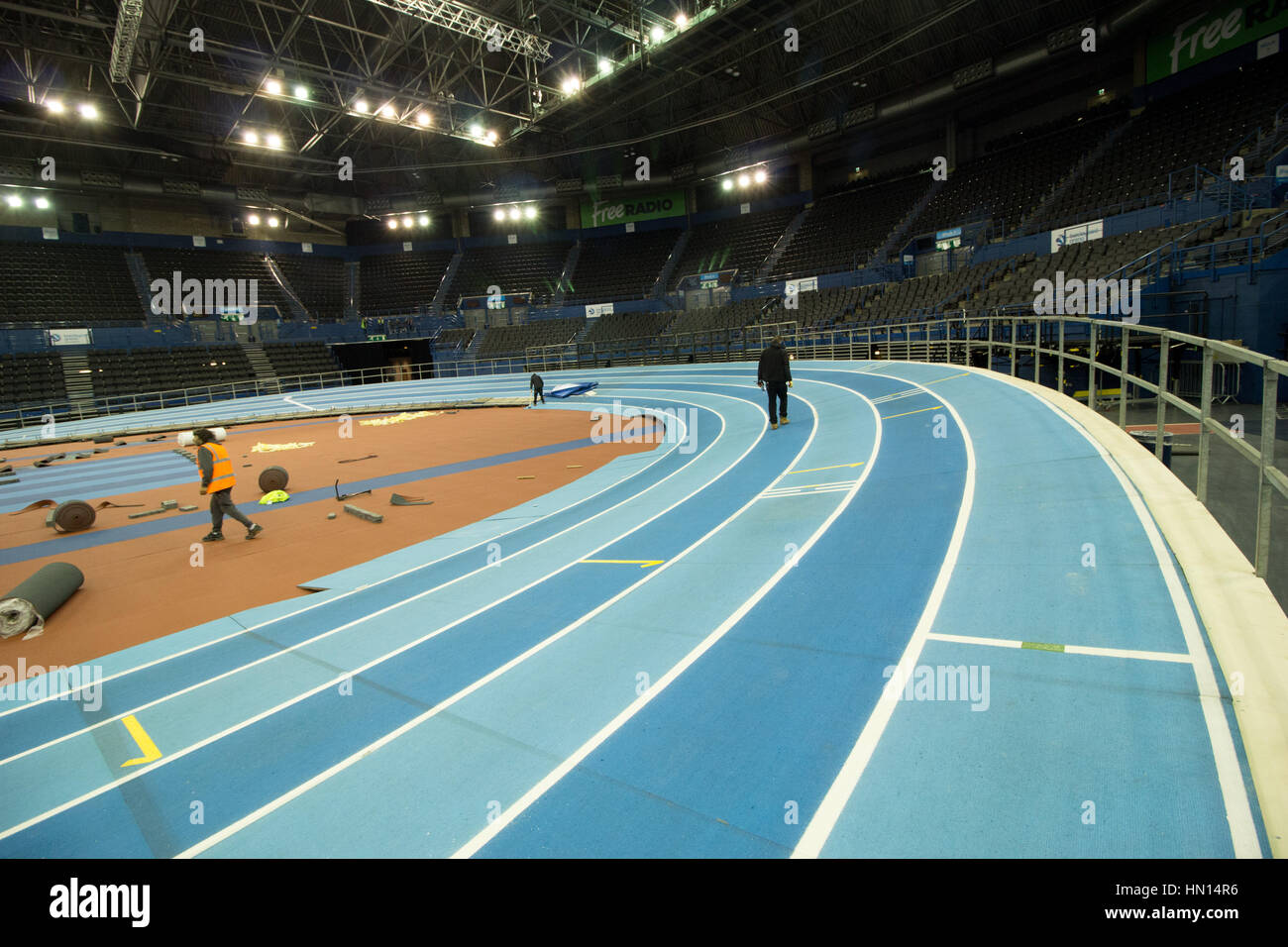 Workers laying the new infield track at the National Indoor Arena in ...