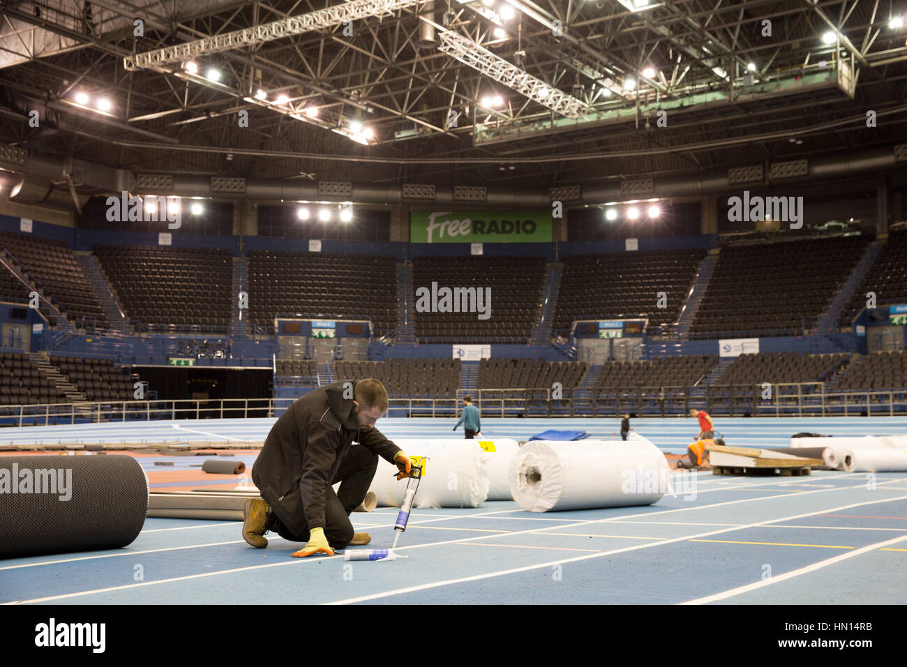 Workers laying the new infield track at the National Indoor Arena in ...