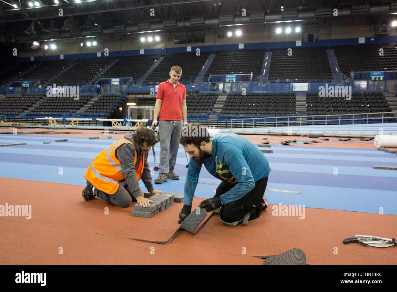 Workers laying the new infield track at the National Indoor Arena in ...
