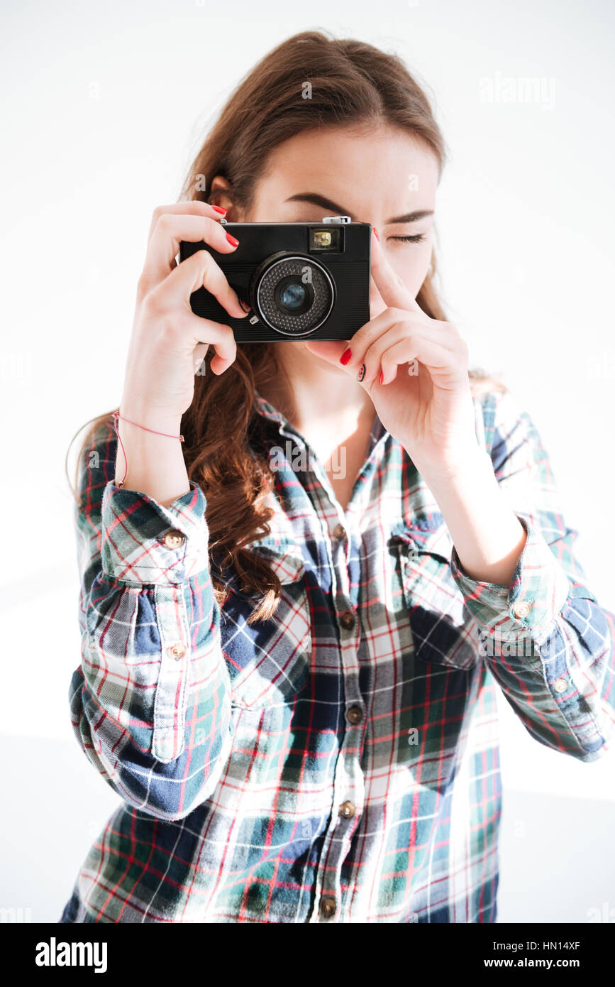 Image of young woman photographer holding camera while standing over ...