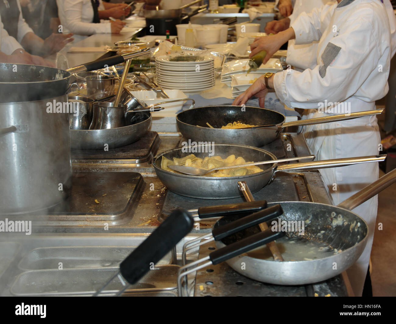 Cooking inside Restaurant's Kitchen, Pans, Dishes and Chef with Uniform ...