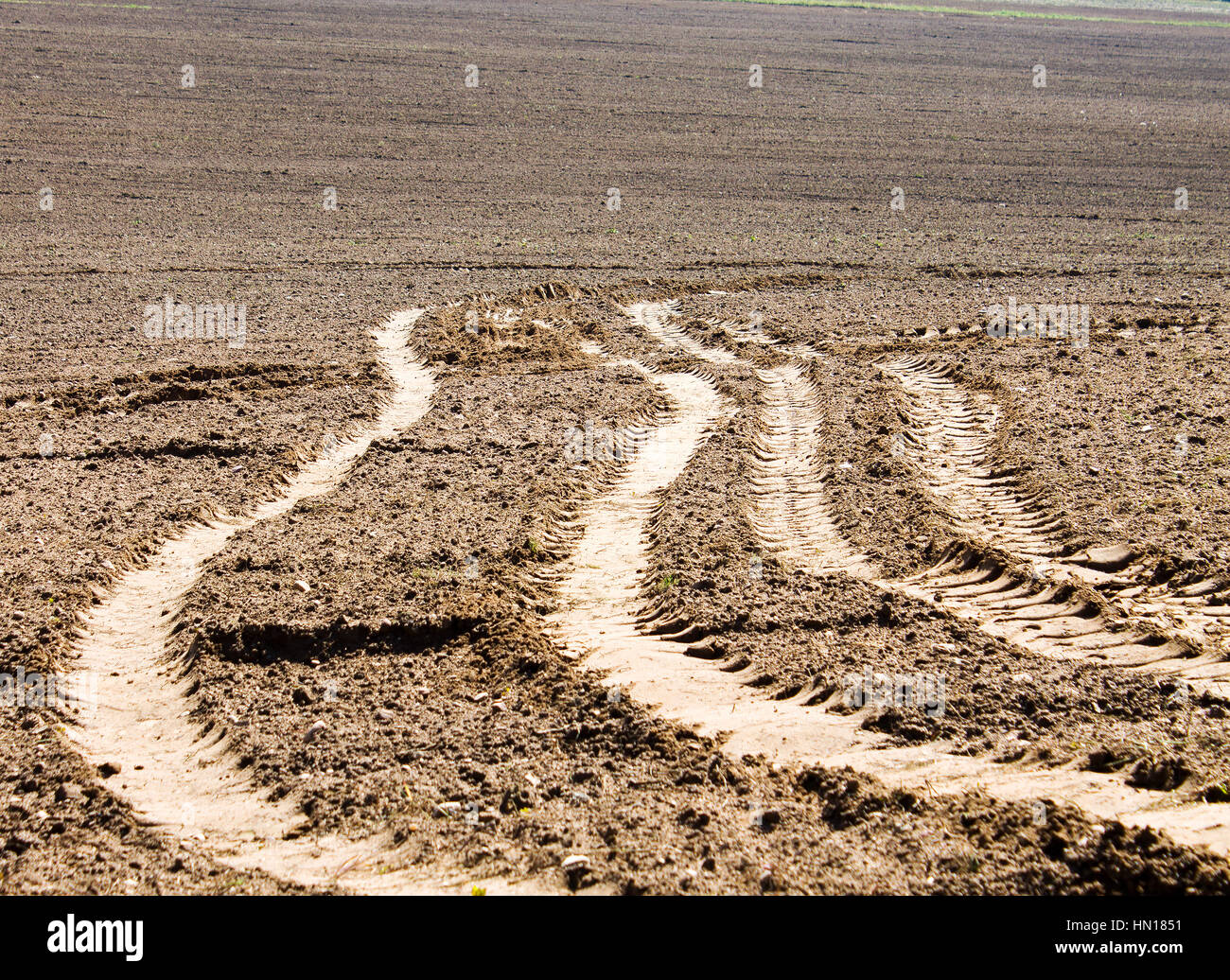Vehicle tracks and footprints on the sandy ground for background.Traces ...