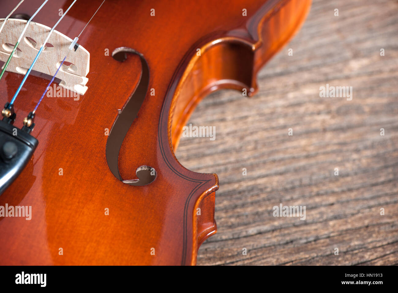 closeup new classical violin on wooden background Stock Photo - Alamy