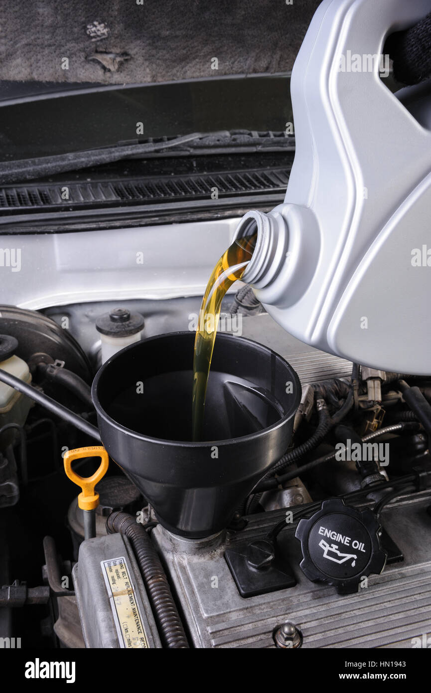 technician pouring fresh motor oil to engine of old car Stock Photo - Alamy