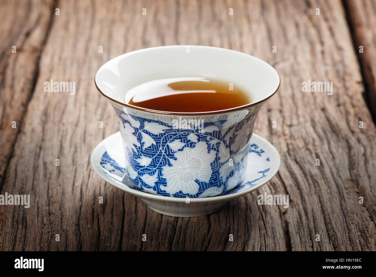 tea cup with tea leaf isolated on wooden plank Stock Photo - Alamy