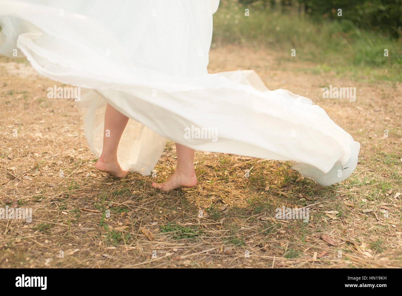 Happy bride dancing walking barefoot on a wedding day. Nice romantic ...