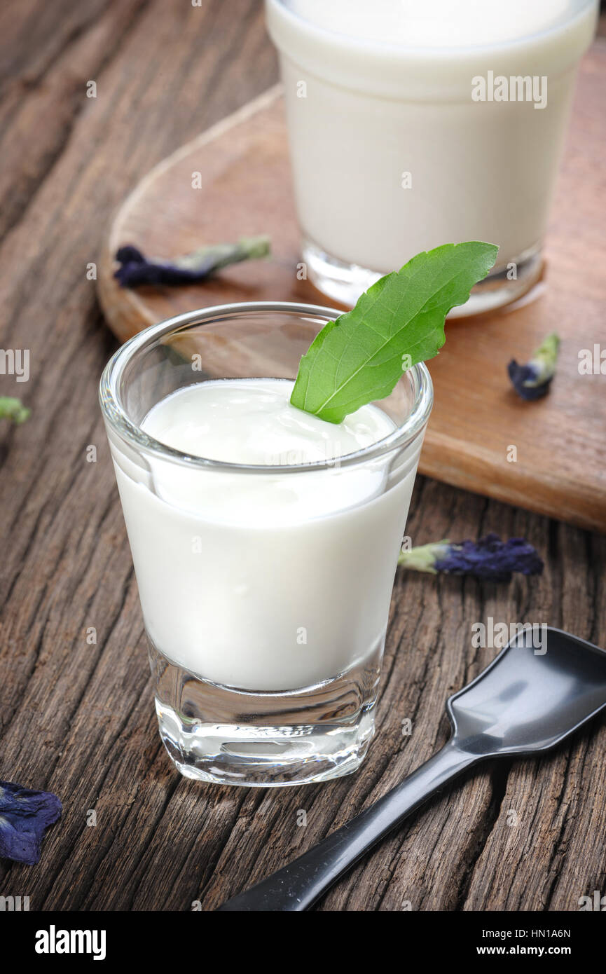fresh natural yogurt in glass on wooden plank Stock Photo - Alamy