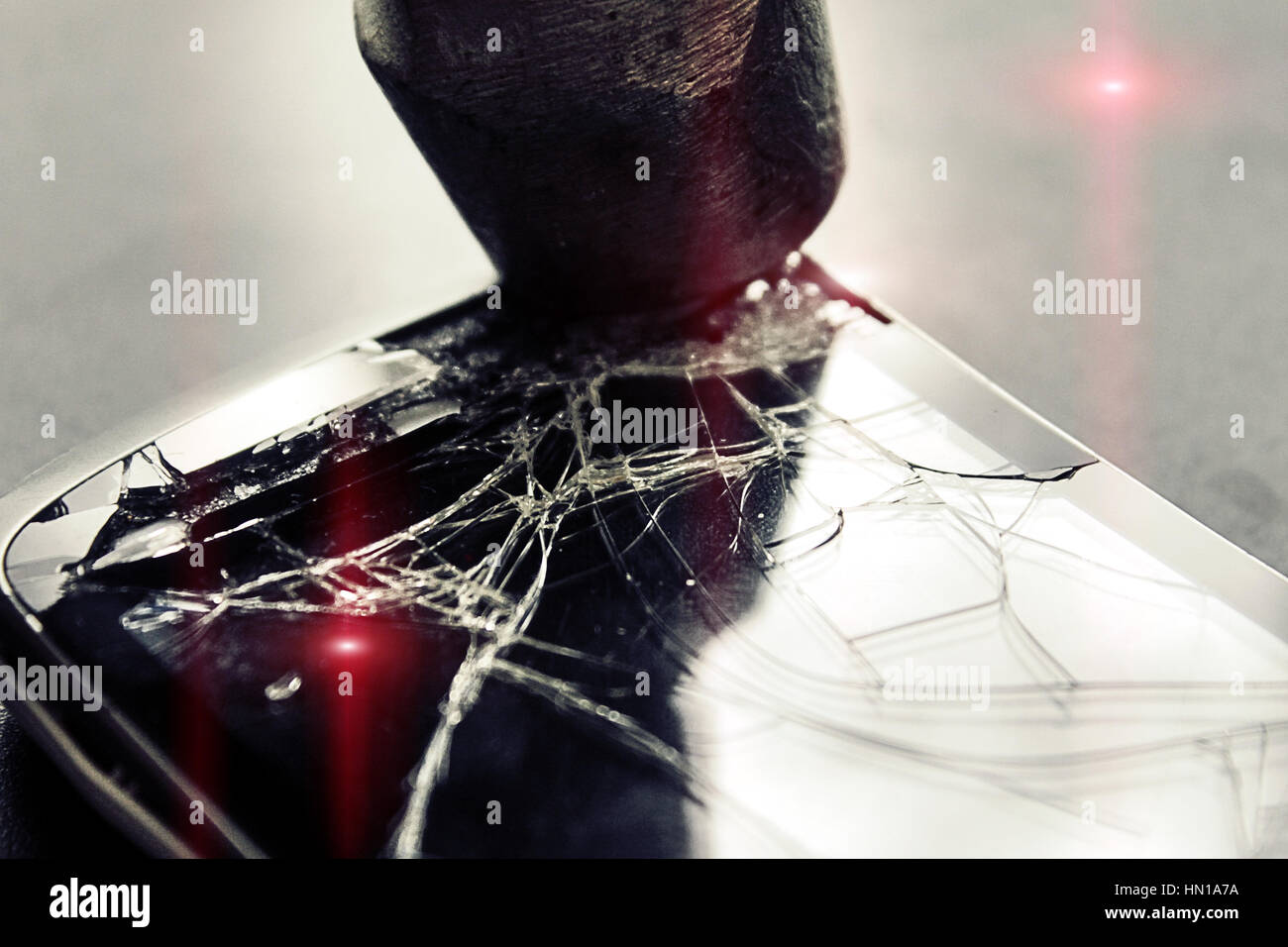 Broken phone screen and hammer on background,a hammer blow to the ...