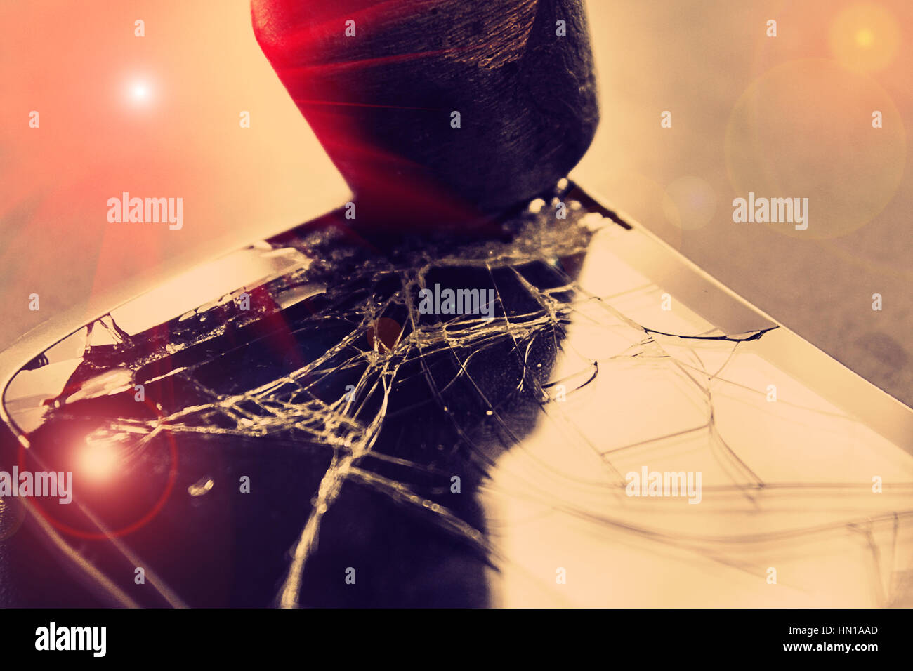 Broken phone screen and hammer on background,a hammer blow to the ...