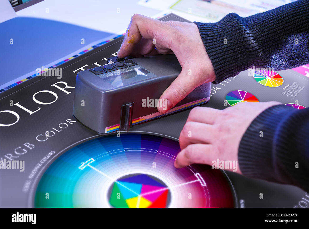 Young man in the process of offset printing and color correction Stock ...