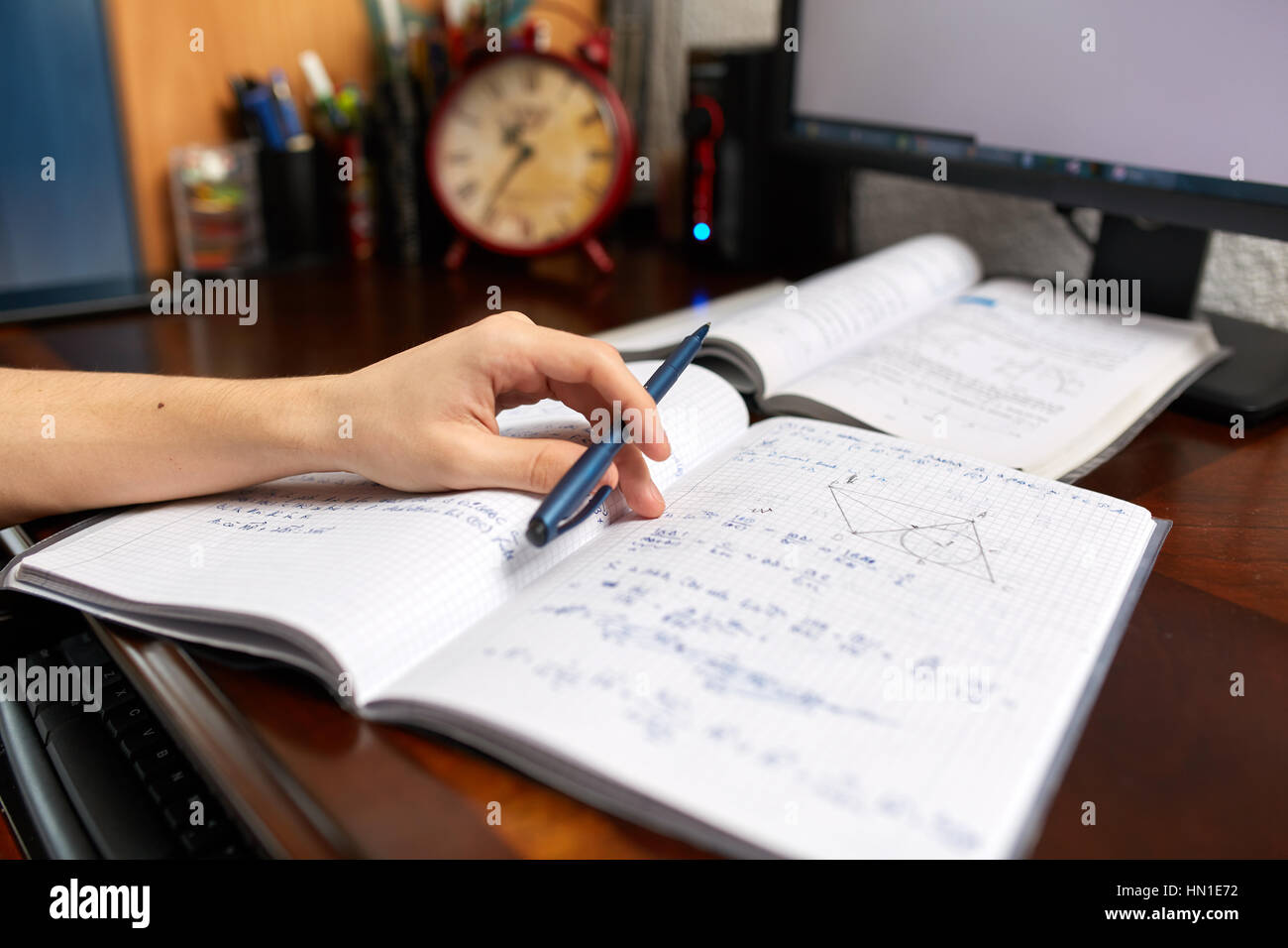 Teenage boy doing homework with the help of computer Stock Photo - Alamy