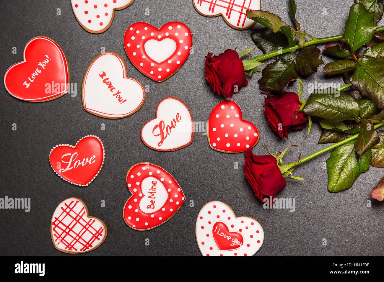 Beautiful gingerbread heart and red roses on a black background ...