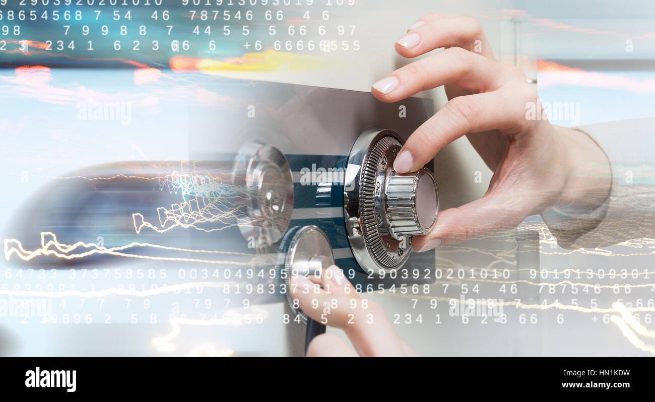Hands of businesswoman dialing code on safe lock Stock Photo - Alamy