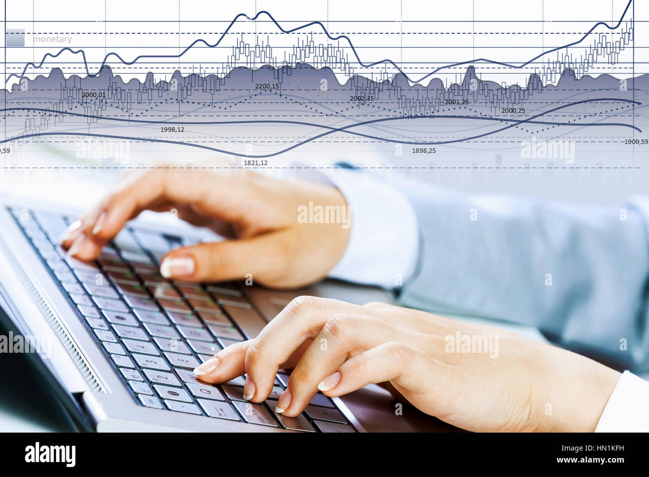 Closeup of female hands using keyboard with abstract business charts and diagrams on office ...