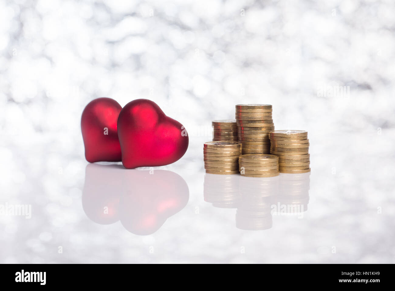 Coins and heart Stock Photo - Alamy
