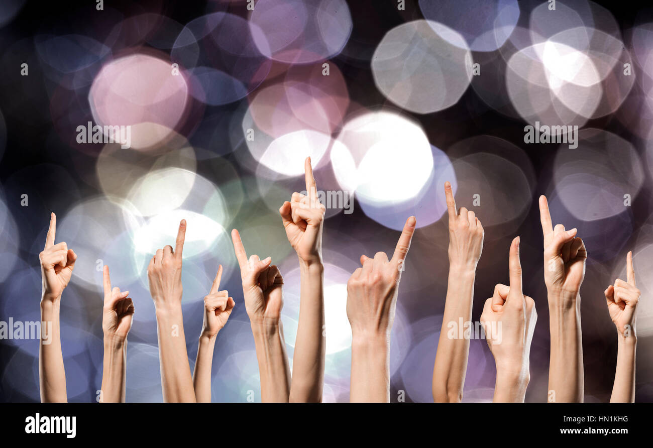 Row of raised hands showing different gestures Stock Photo - Alamy