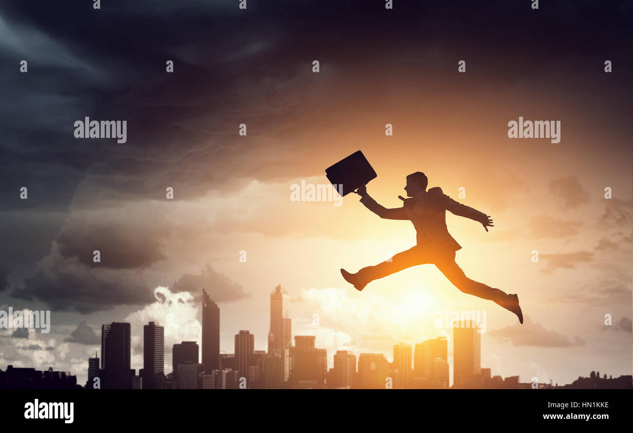 Silhouette businessman jumping over night hi-res stock photography and ...