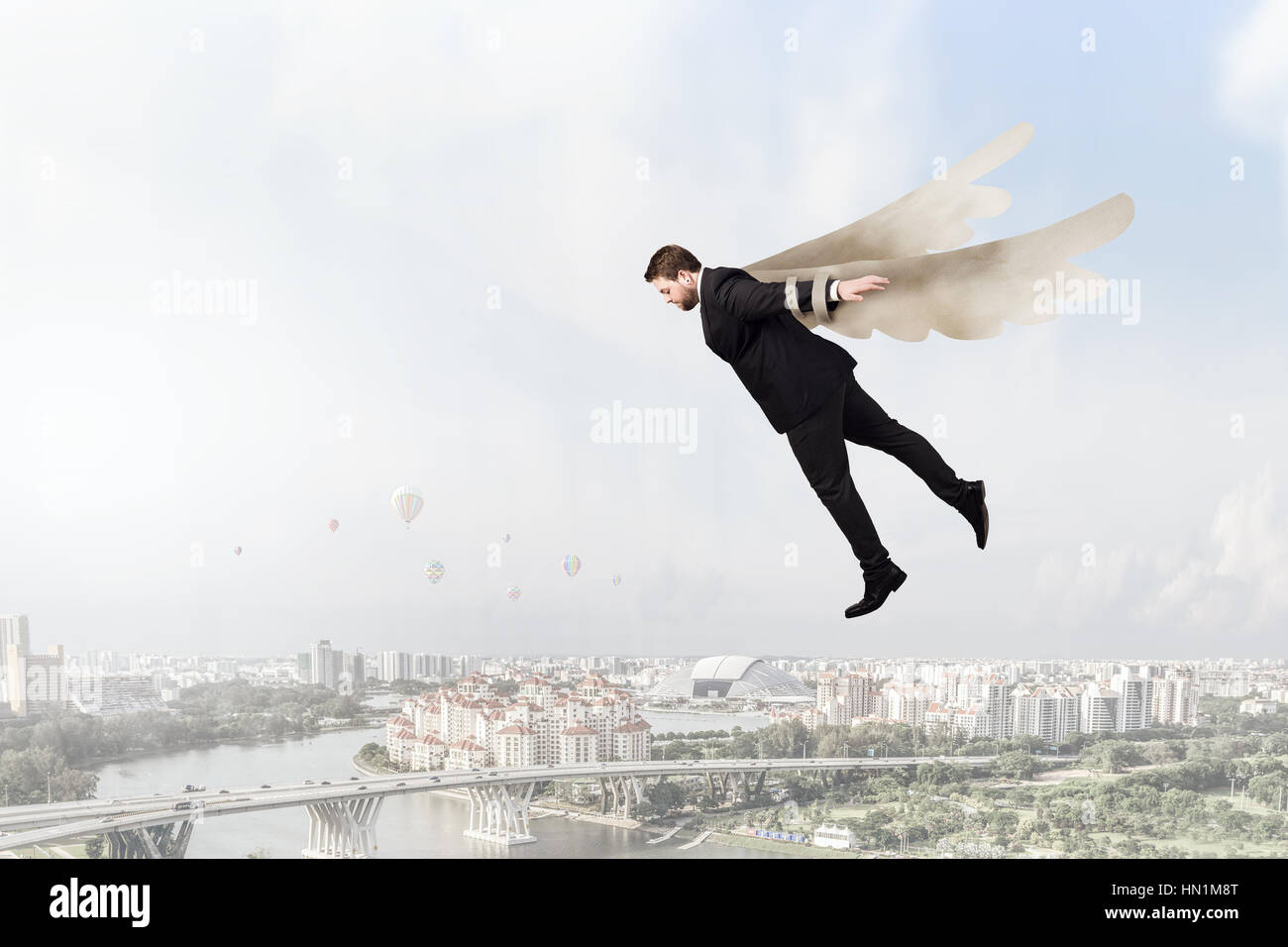 Young businessman with paper wings flying in sky Stock Photo - Alamy