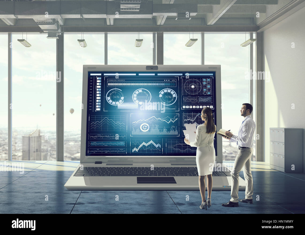 Young businesspeople and huge laptop with infographs on screen. Mixed ...