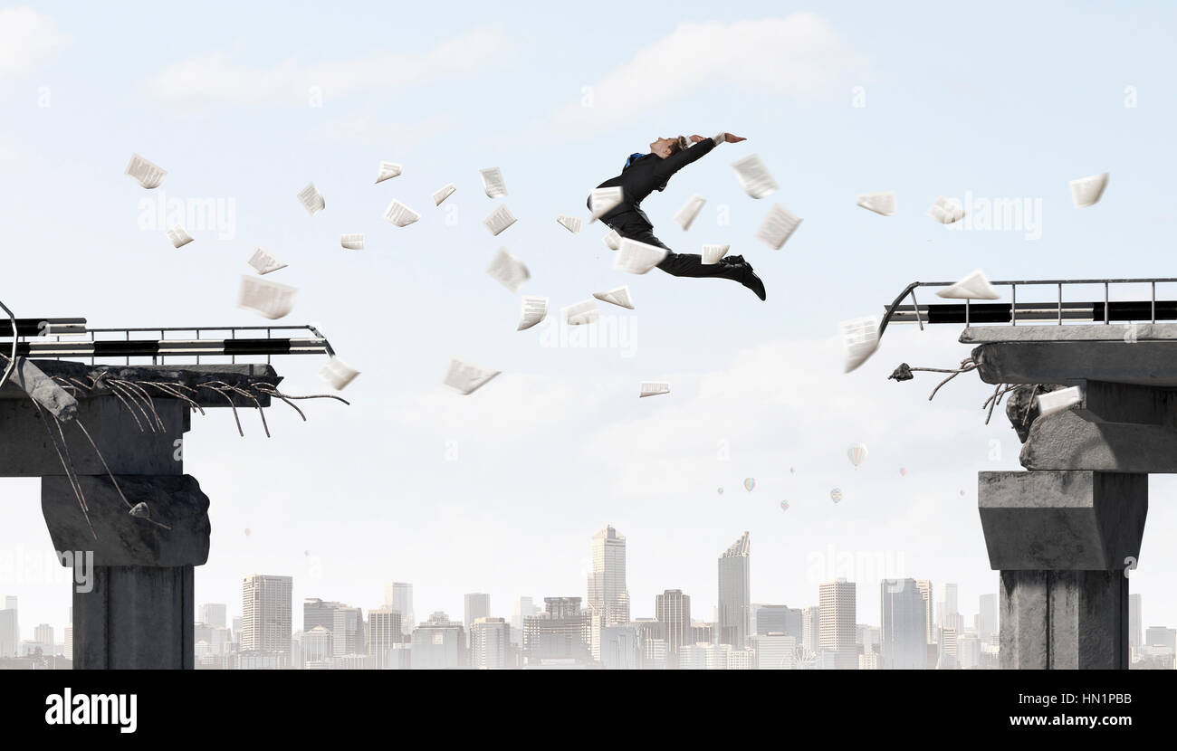 Businessman jumping over a gap in bridge as symbol of problem ...