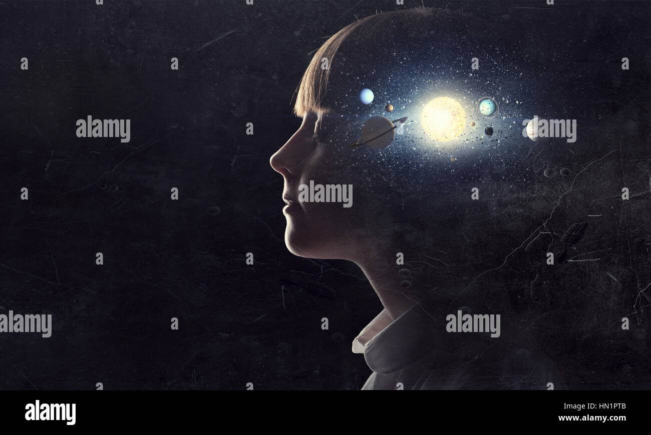 Profile of dreaming kid girl against dark concrete background Stock ...