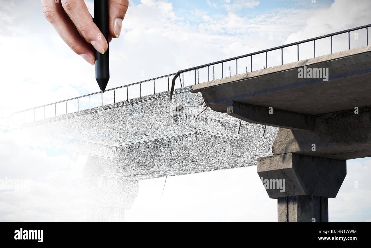 Hand of female drawing elements of crashed bridge Stock Photo - Alamy
