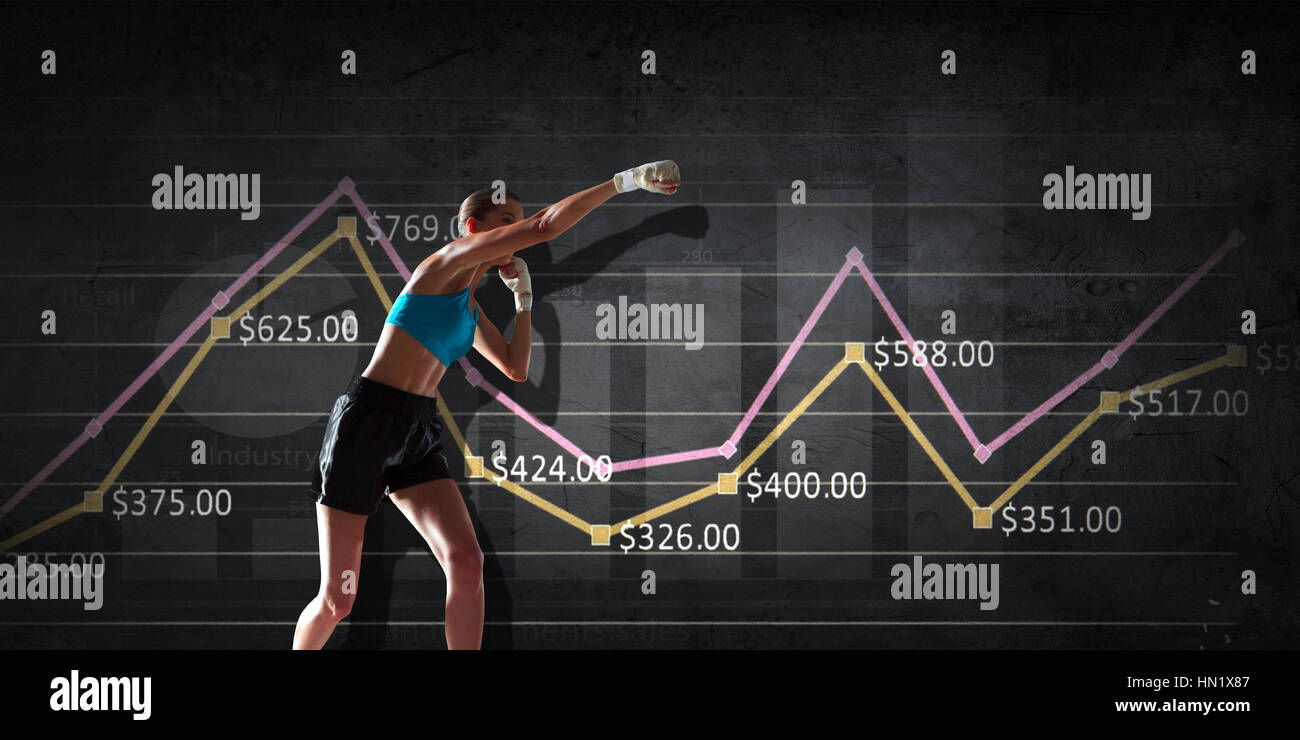 Young woman boxing against graphs background. Mixed media Stock Photo ...