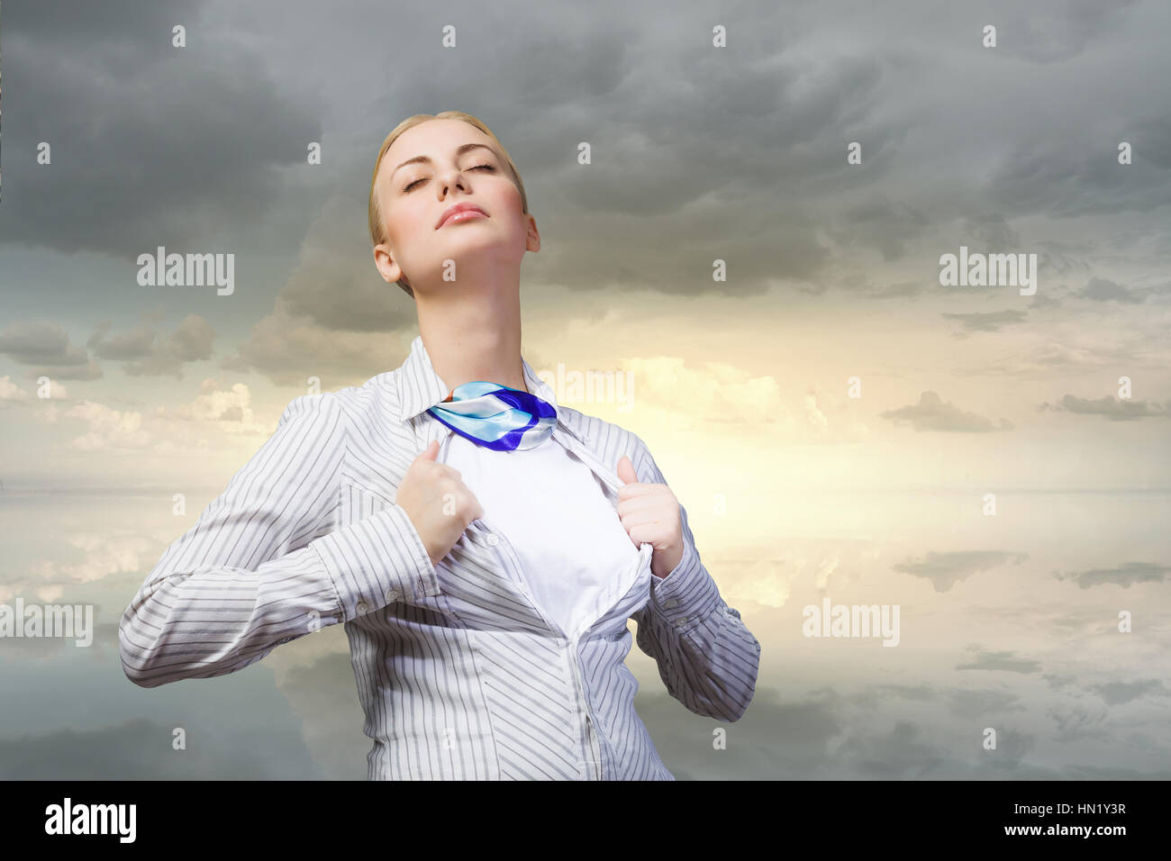 Young businesswoman tearing shirt on chest and acting like super hero ...