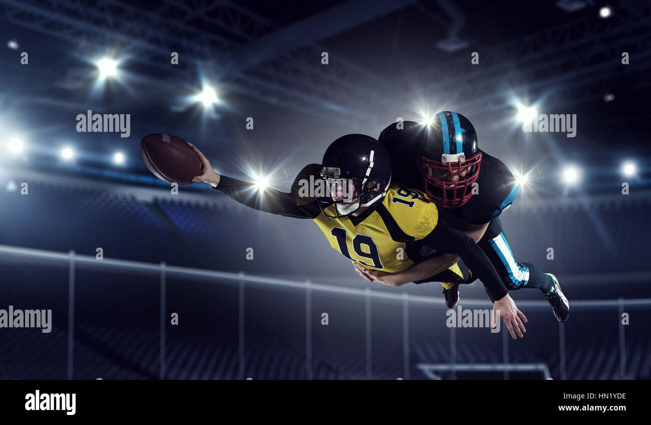 Two american football players fighting for ball. Mixed media Stock ...