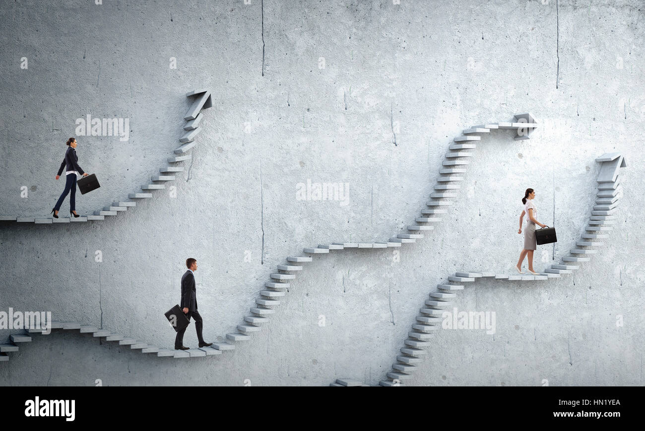 Young businesspeople reaching up staircase as symbol of growth and ...