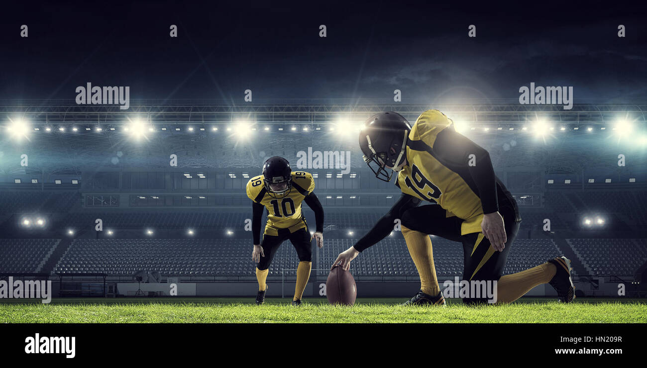 Two american football players fighting for ball. Mixed media Stock ...