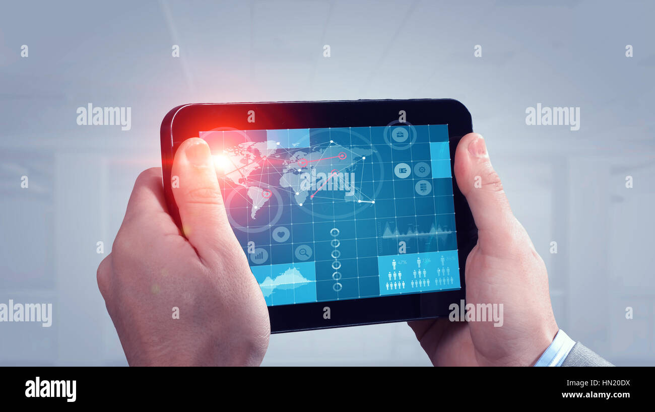 Close of businessman hands using tablet pc with infographs. Mixed media ...