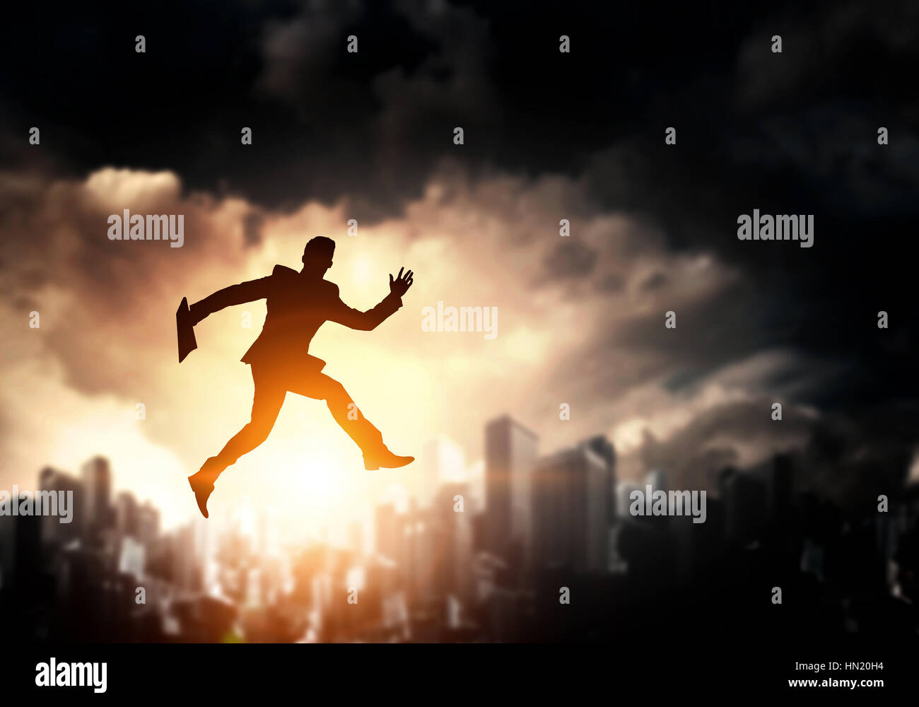Silhouette businessman jumping over night hi-res stock photography and ...