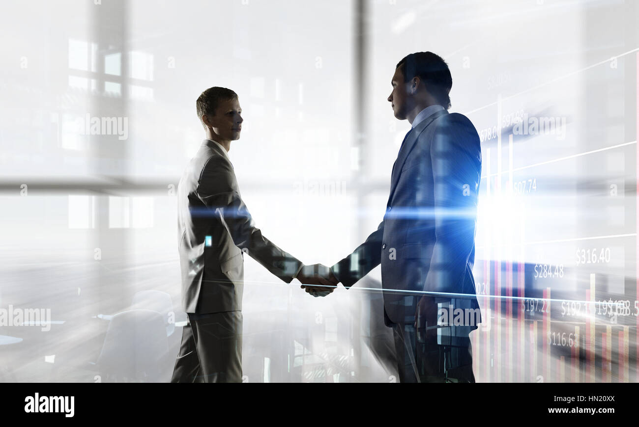 Two businessmen shaking hands to greet each other. Mixed media Stock ...