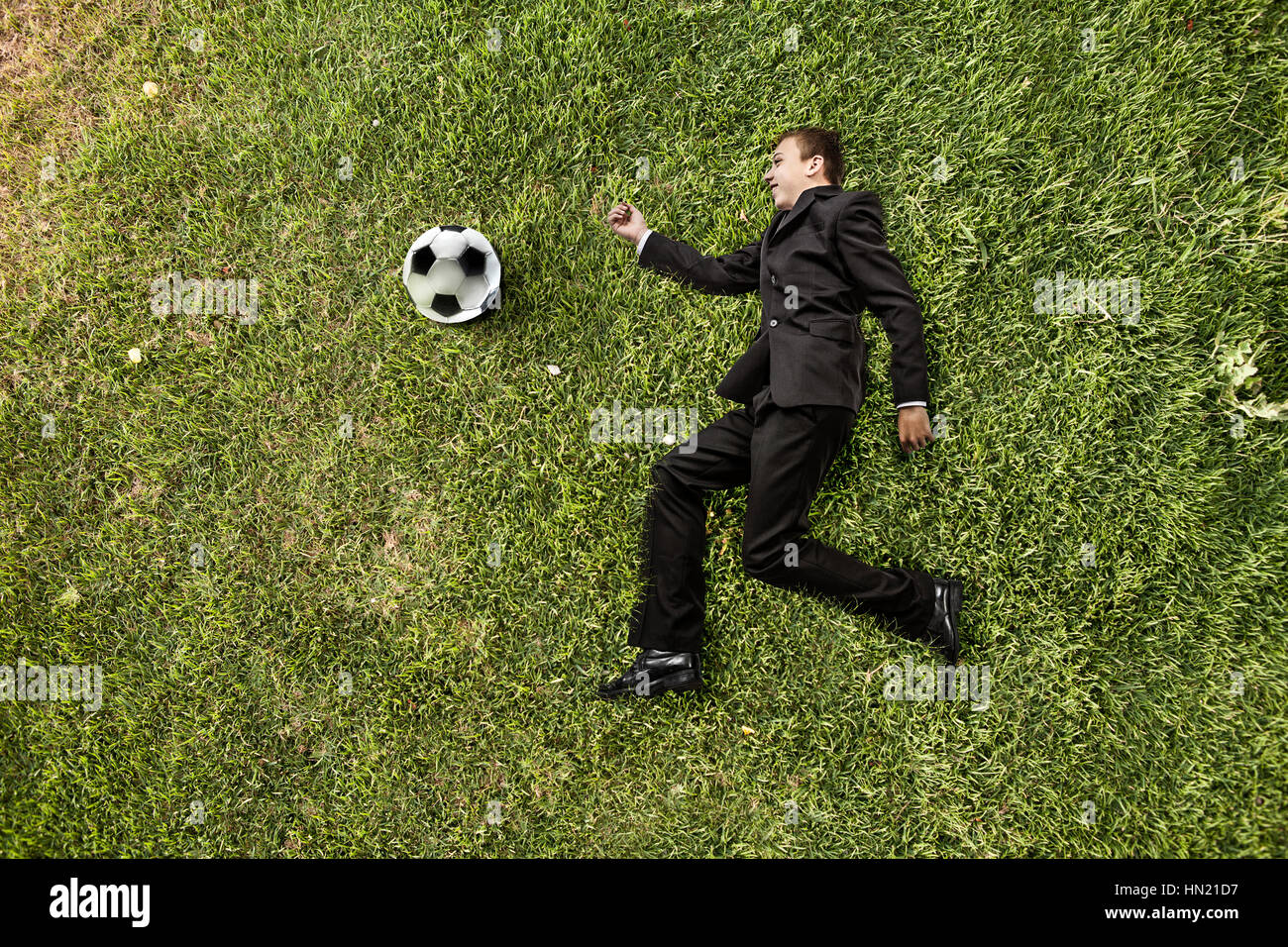 Man in suit kicking football hi-res stock photography and images - Alamy