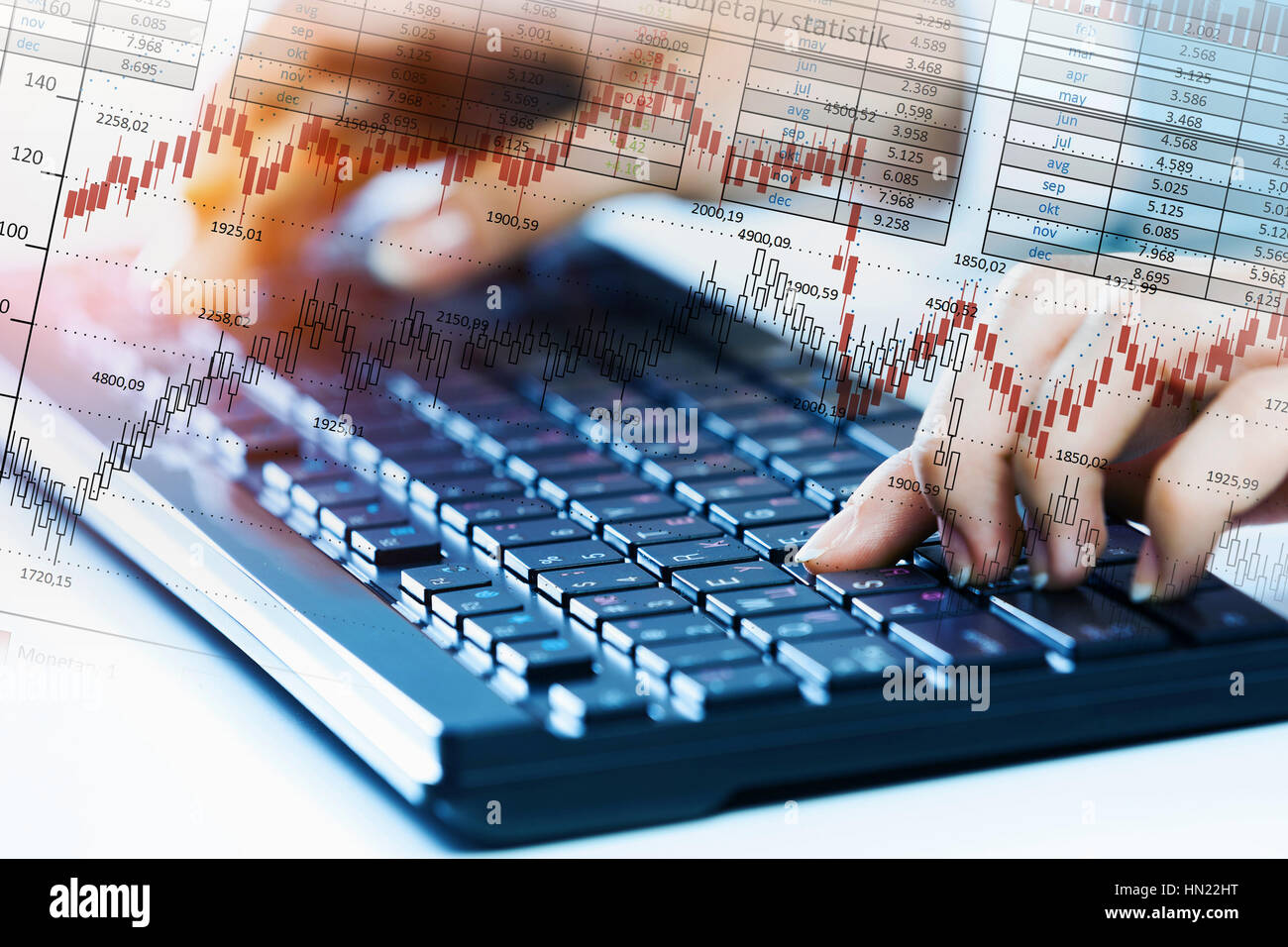 Closeup of female hands using keyboard with abstract business charts and diagrams on office ...