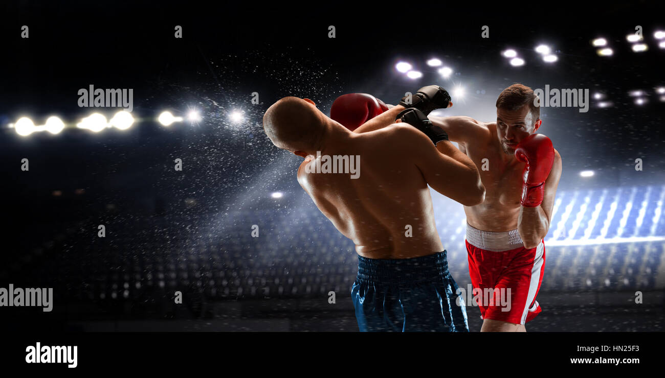Two professional boxers are fighting on grand arena. Mixed media Stock ...