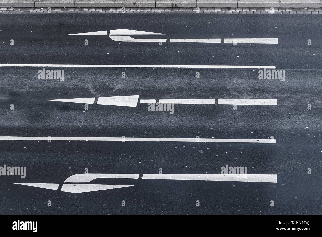 arrows painted on street surface asphalt pointing in different ...