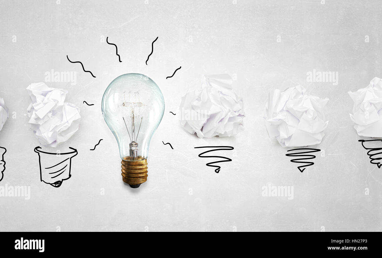 Glowing light bulb and paper balls on white background Stock Photo - Alamy