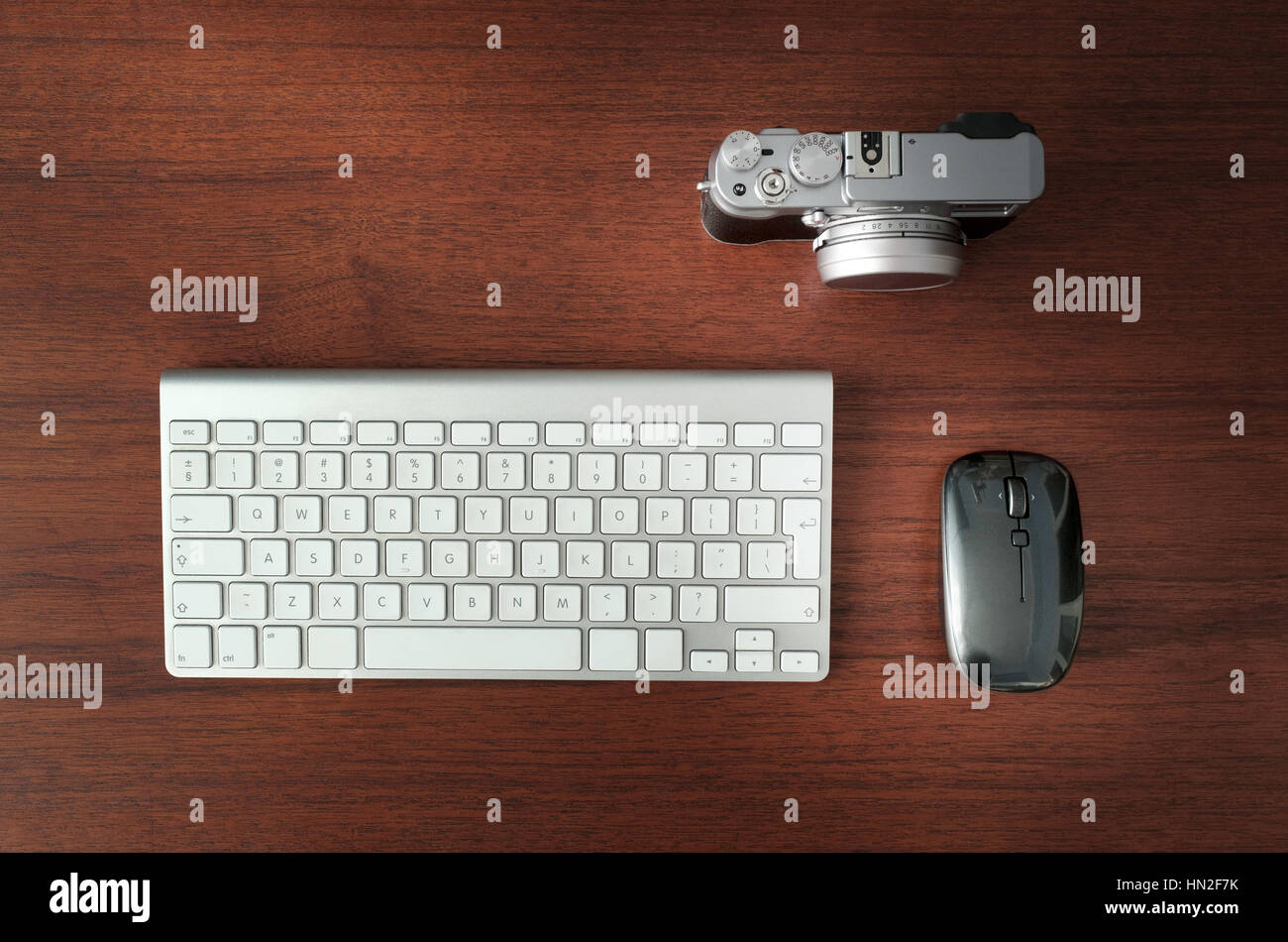 Digital mirrorless camera, mouse and keyboard on brown wood desk Stock ...