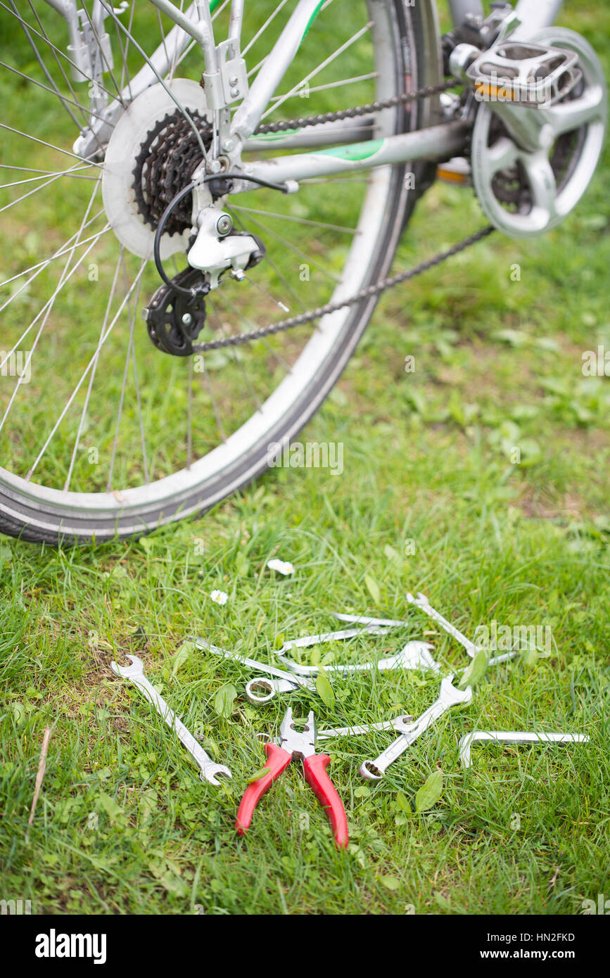 set of keys to repair the bike lying on the grass Stock Photo - Alamy