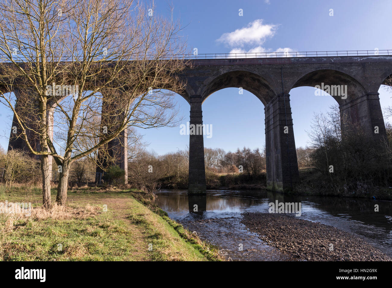 Railway viaduct over the river Tame at Reddish Vale country park ...