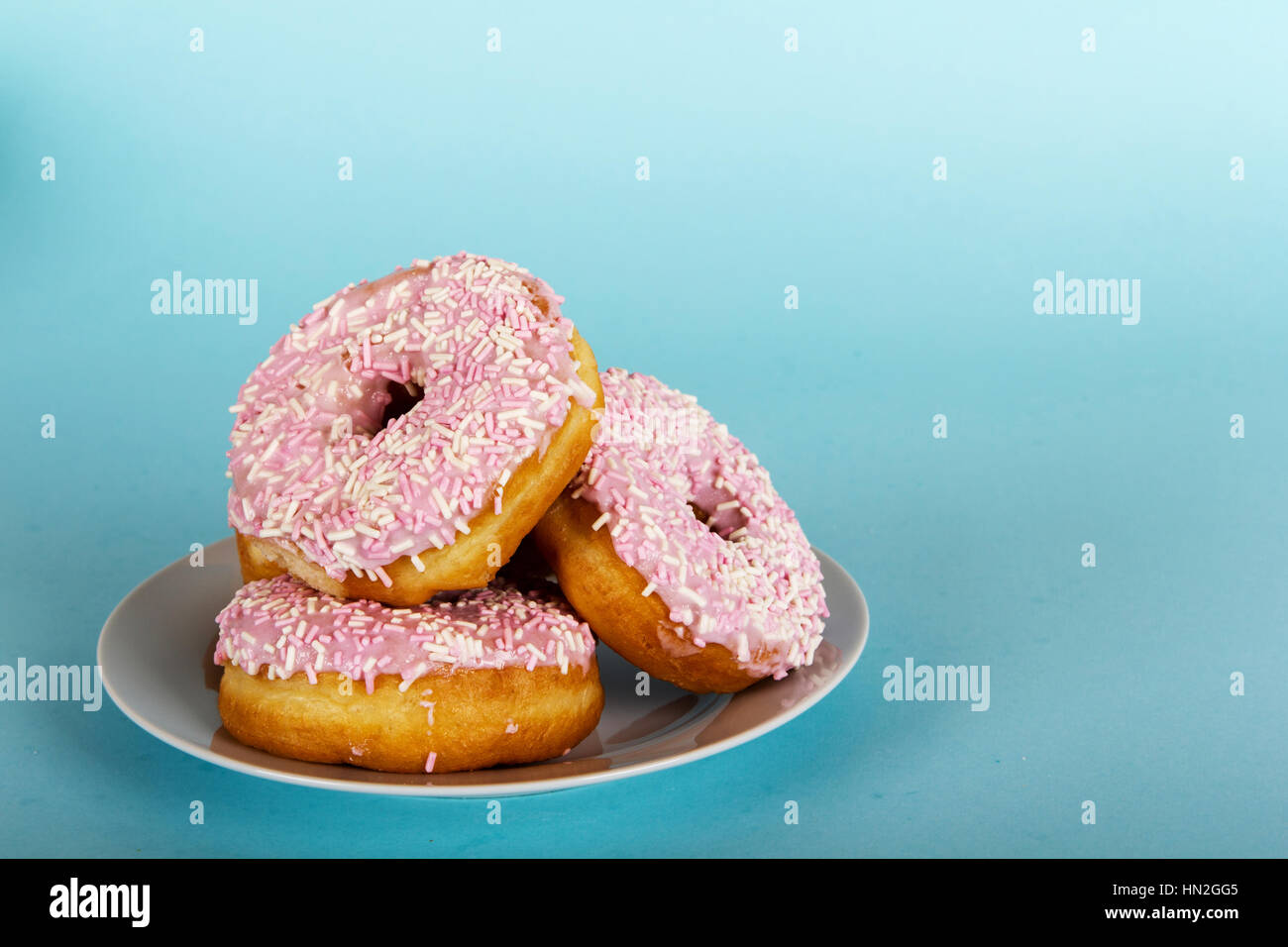 Iced doughnut on a light coloured blue background Stock Photo - Alamy