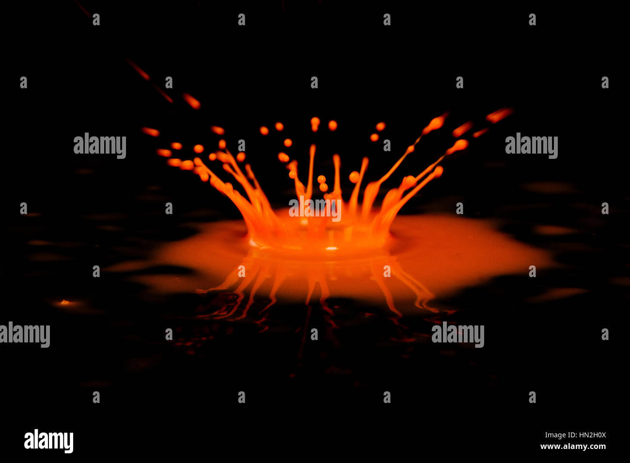 Colorful paint drop splashing on black a background Stock Photo - Alamy