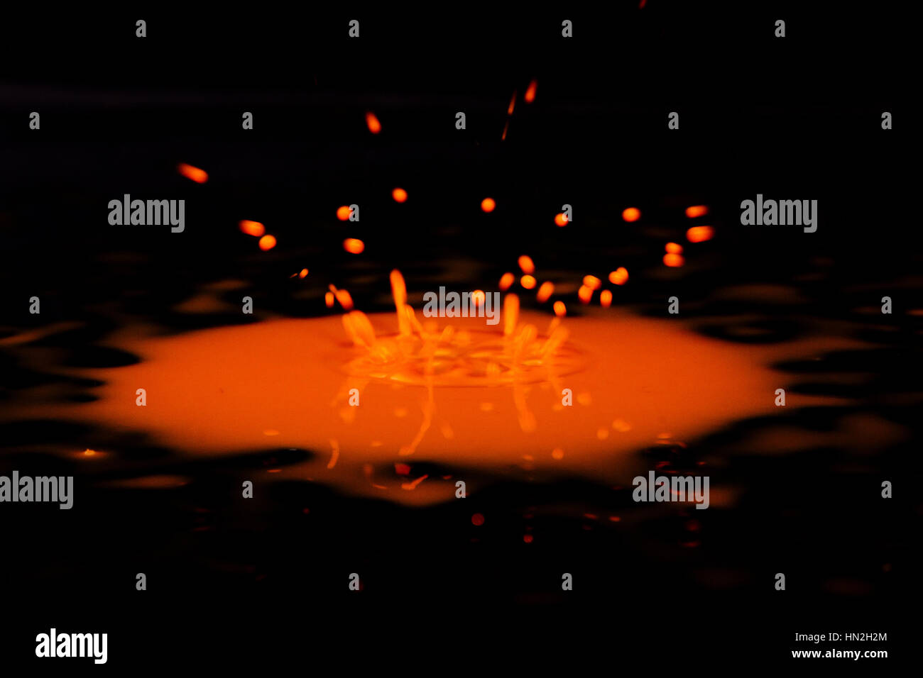 Colorful paint drop splashing on black a background Stock Photo - Alamy